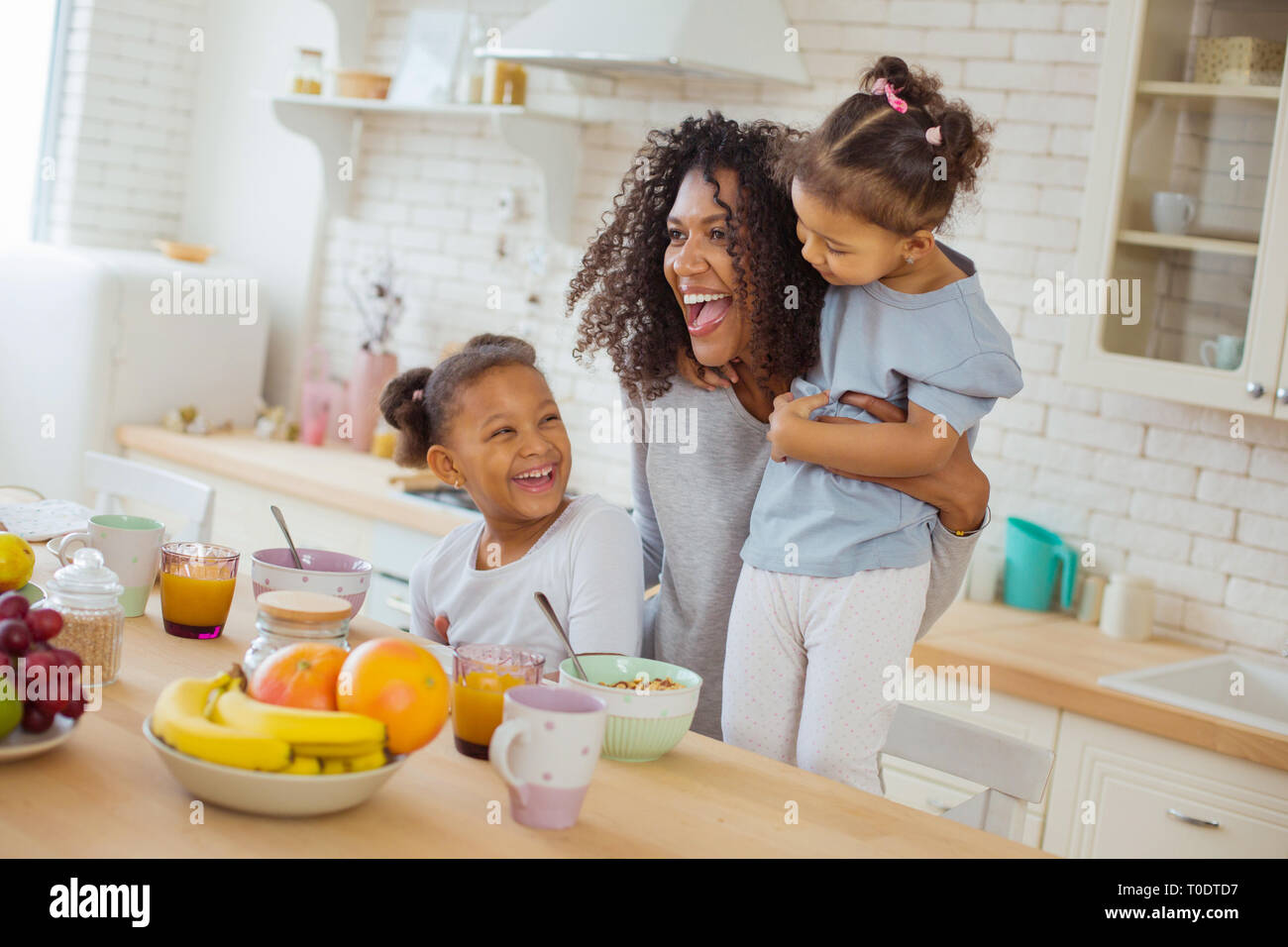 Positive delighted woman playing with her kids Stock Photo - Alamy