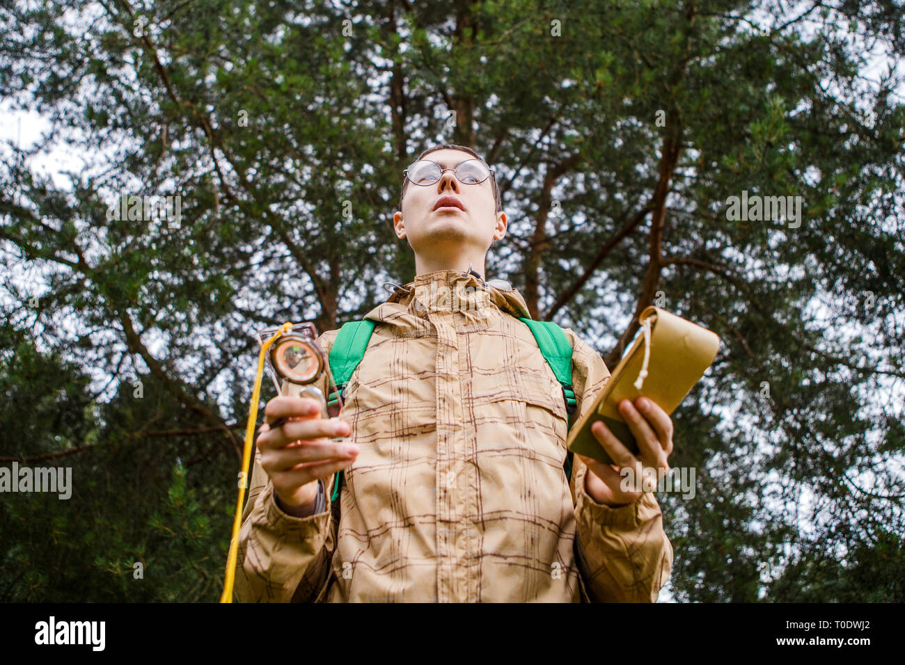 Image from below of man with compass Stock Photo - Alamy