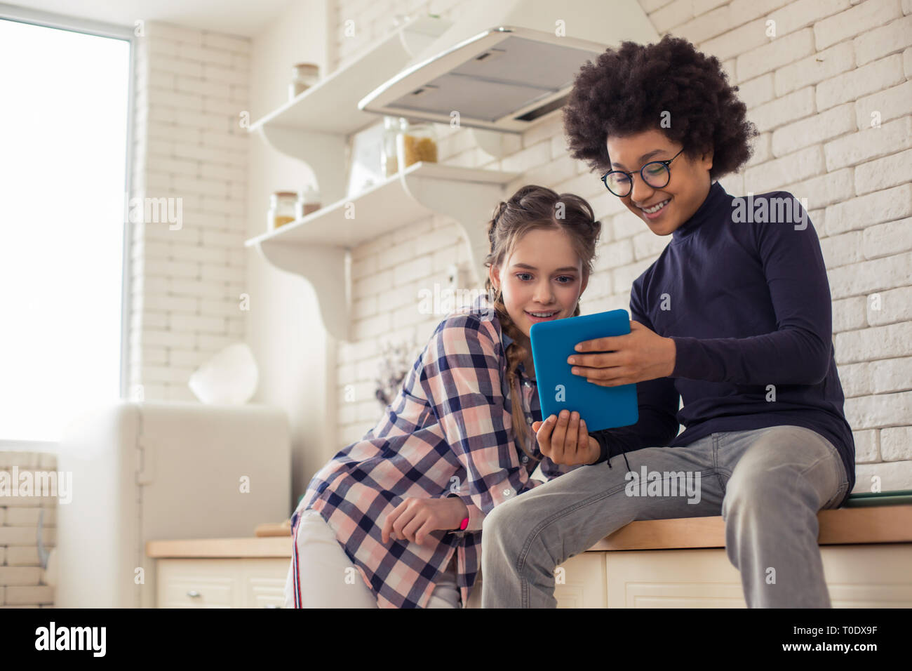 Emotional blonde girl staring at screen of tablet Stock Photo - Alamy