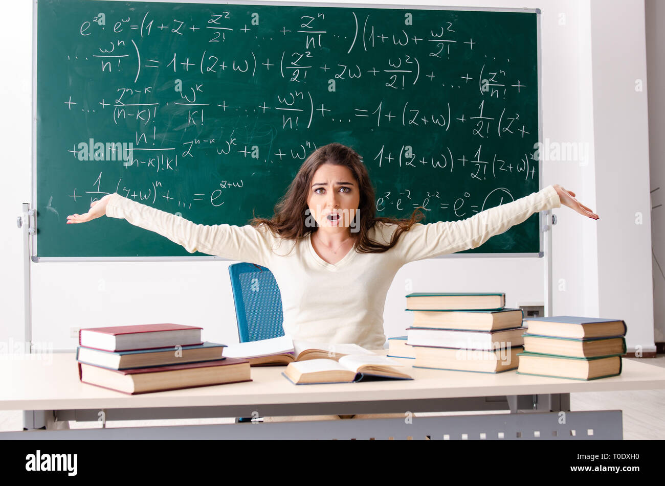 Young female math teacher in front of chalkboard Stock Photo - Alamy