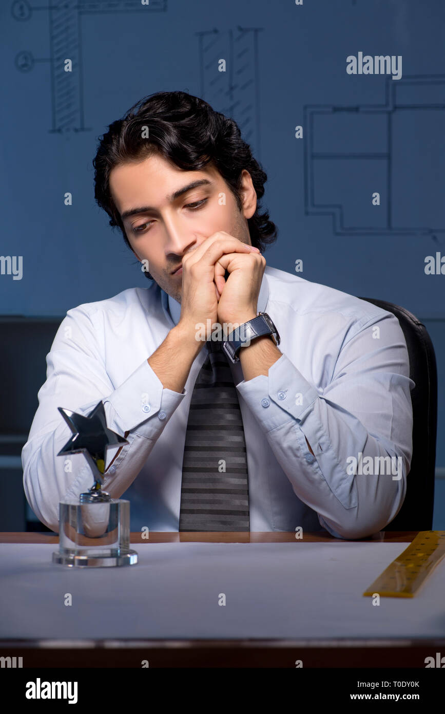 Young construction architect working on project at night Stock Photo ...