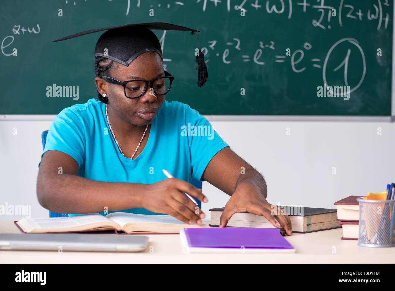 Black female student in front of chalkboard Stock Photo - Alamy
