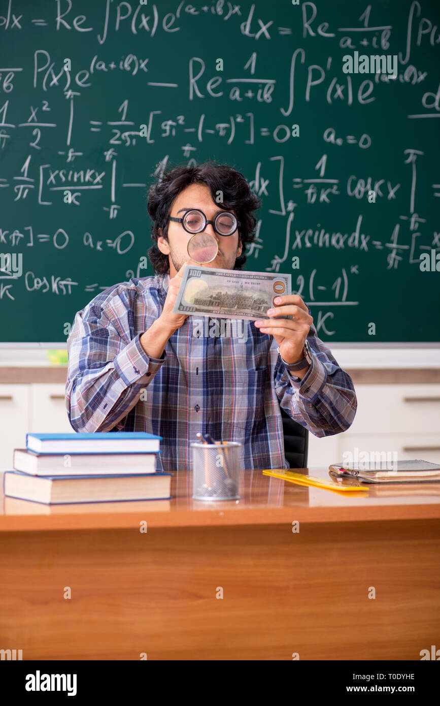 Funny male math teacher in the classroom Stock Photo - Alamy