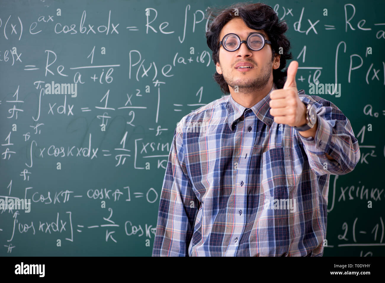 Funny male math teacher in the classroom Stock Photo - Alamy