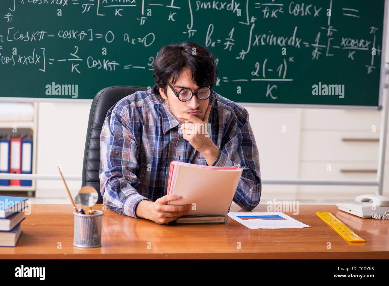 Funny male math teacher in the classroom Stock Photo - Alamy