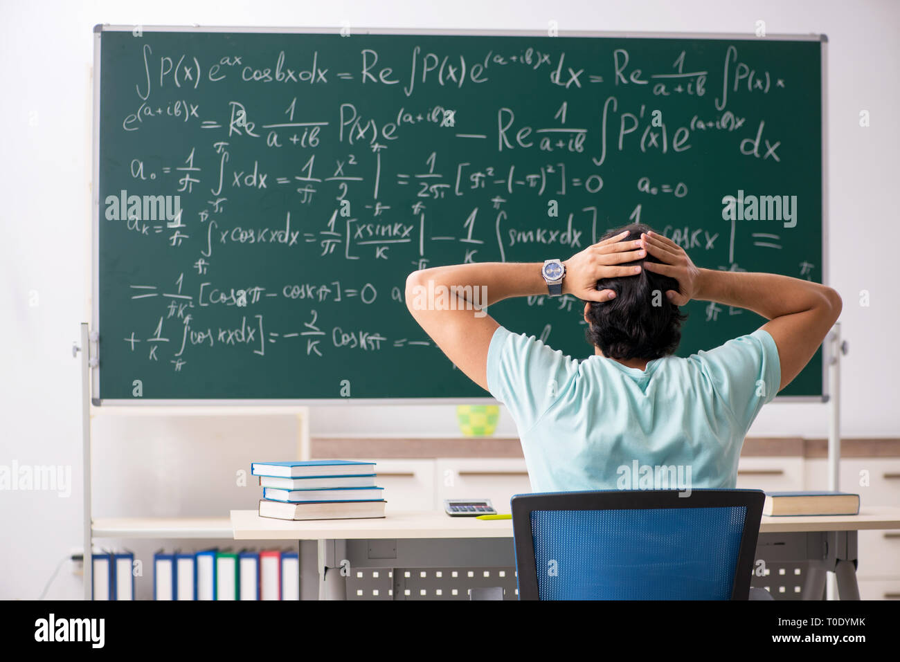 Young male student mathematician in front of chalkboard Stock Photo - Alamy
