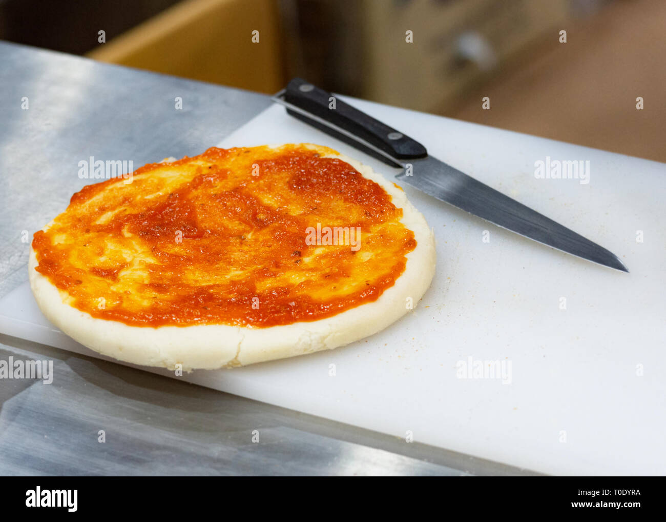 Hand preparing pizza crust sauce hi-res stock photography and images ...