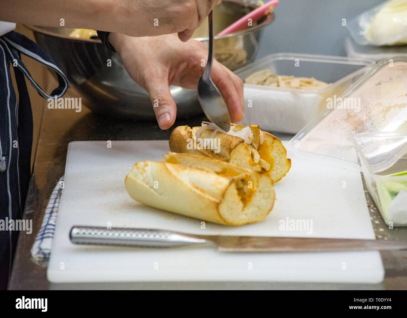 chef prepares sandwich in the kitchen, Delicious sandwich with veggies ...
