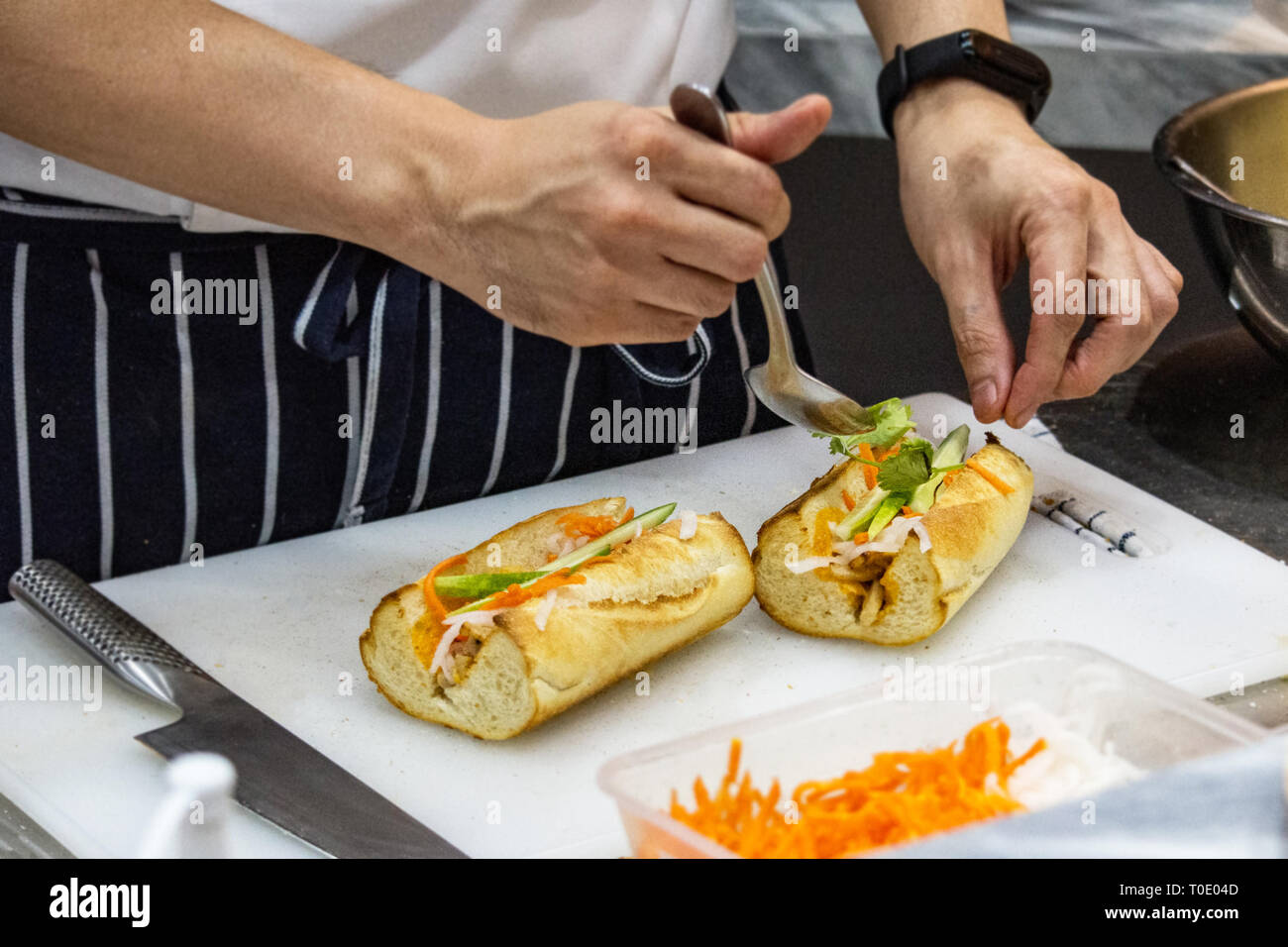 chef prepares sandwich in the kitchen, Delicious sandwich with veggies ...