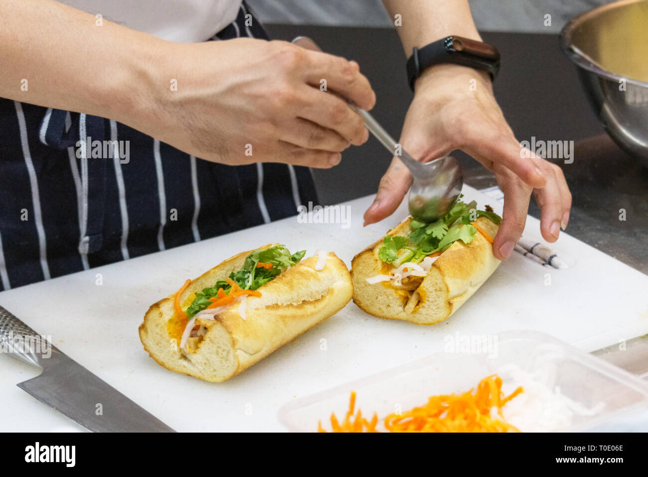 chef prepares sandwich in the kitchen, Delicious sandwich with veggies ...