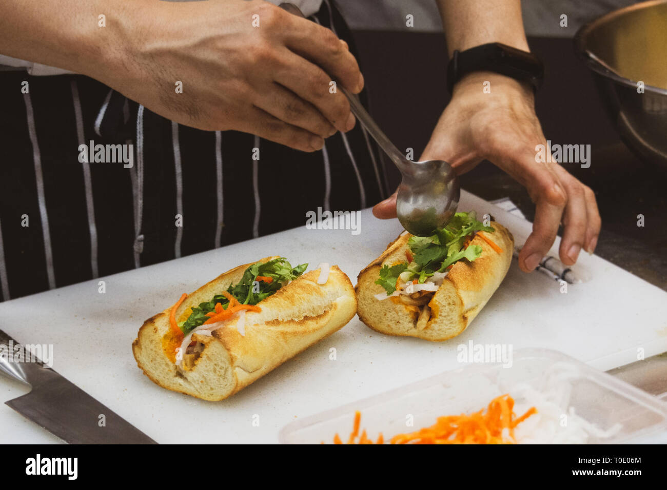 chef prepares sandwich in the kitchen, Delicious sandwich with veggies ...