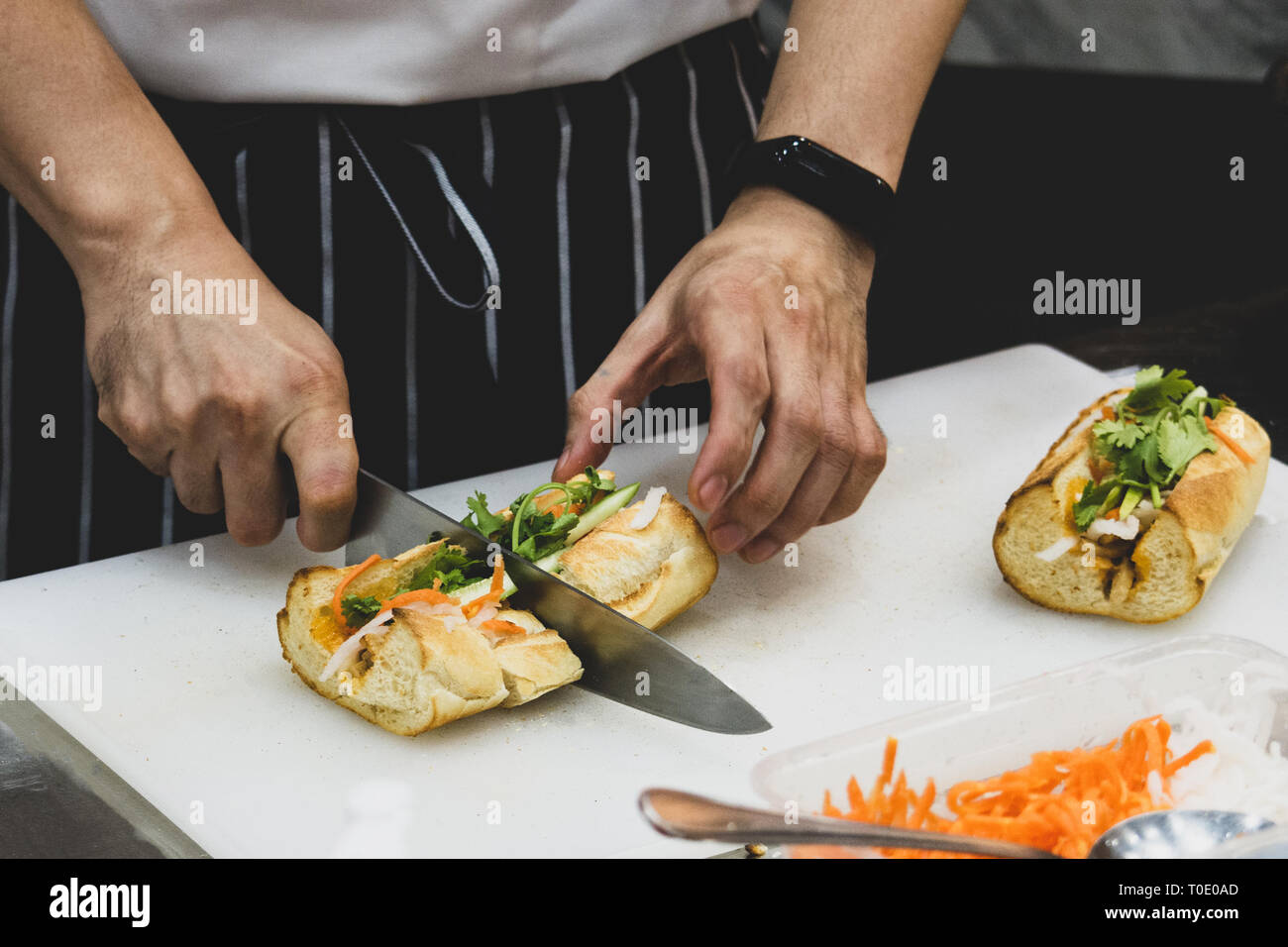 chef prepares sandwich in the kitchen, Delicious sandwich with veggies ...