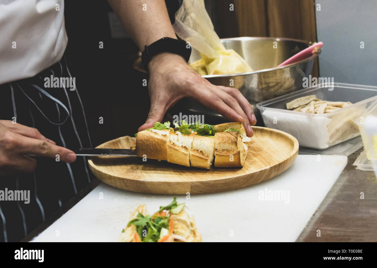 chef prepares sandwich in the kitchen, Delicious sandwich with veggies ...