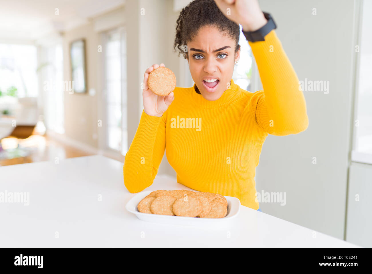 Girl eating biscuit african hi-res stock photography and images - Alamy