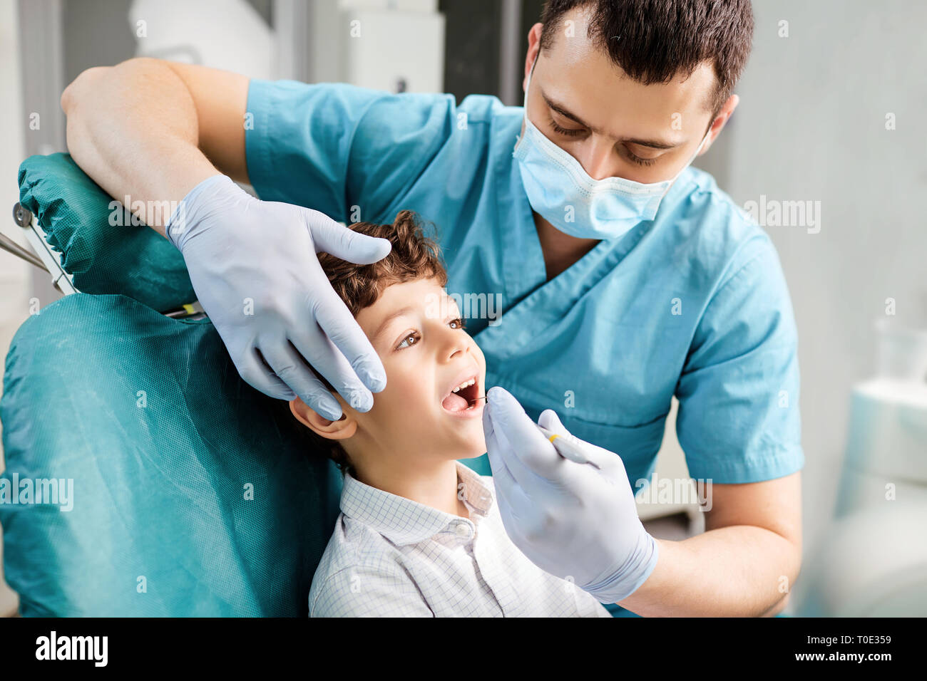 Dentist treats teeth of a teenager in a dental clinic Stock Photo - Alamy