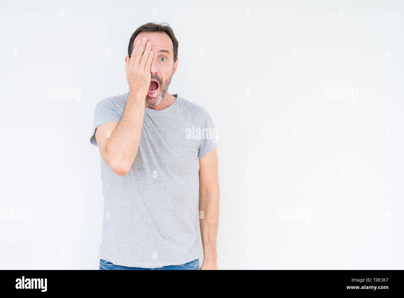 Handsome senior man over isolated background Yawning tired covering ...