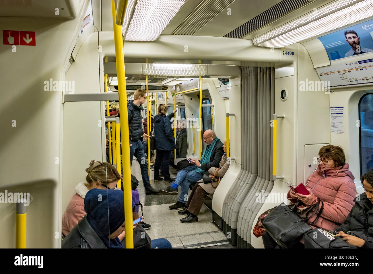 People sitting and standing on a on a S7 stock District Line train on ...