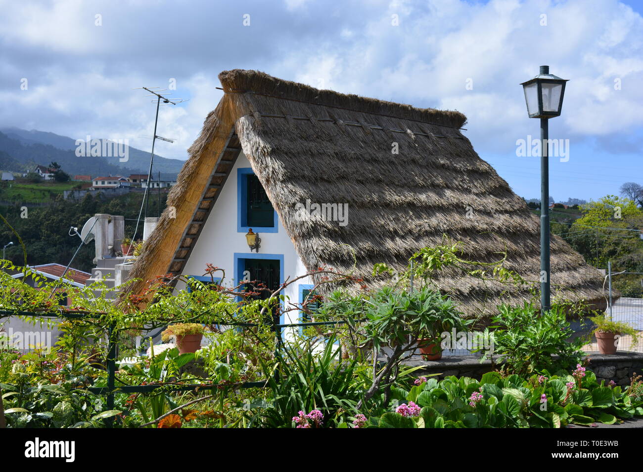 Typical stone houses, painted red, white and blue, with triangular ...