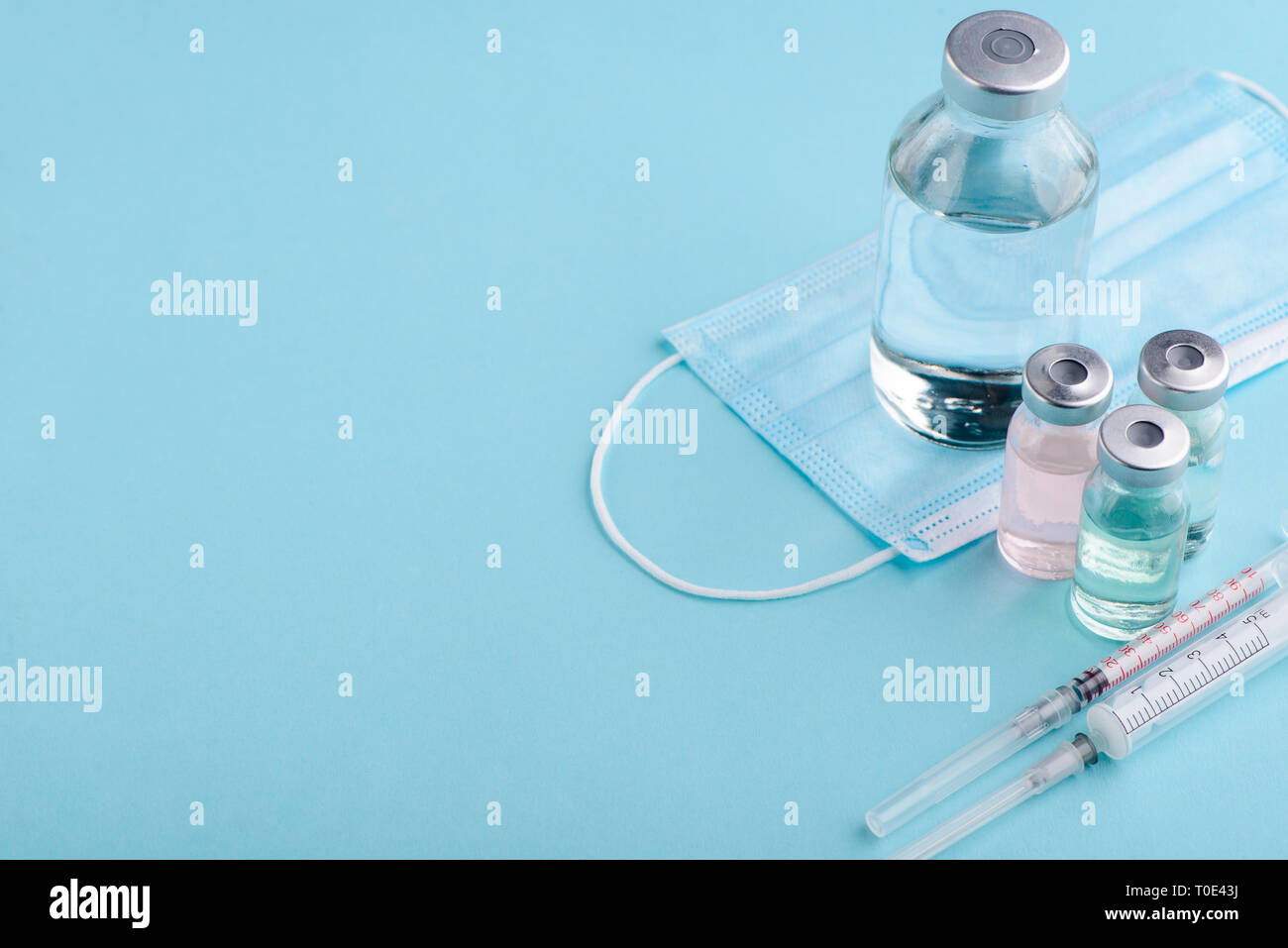 Vials, bottle, syringes and mask Stock Photo - Alamy