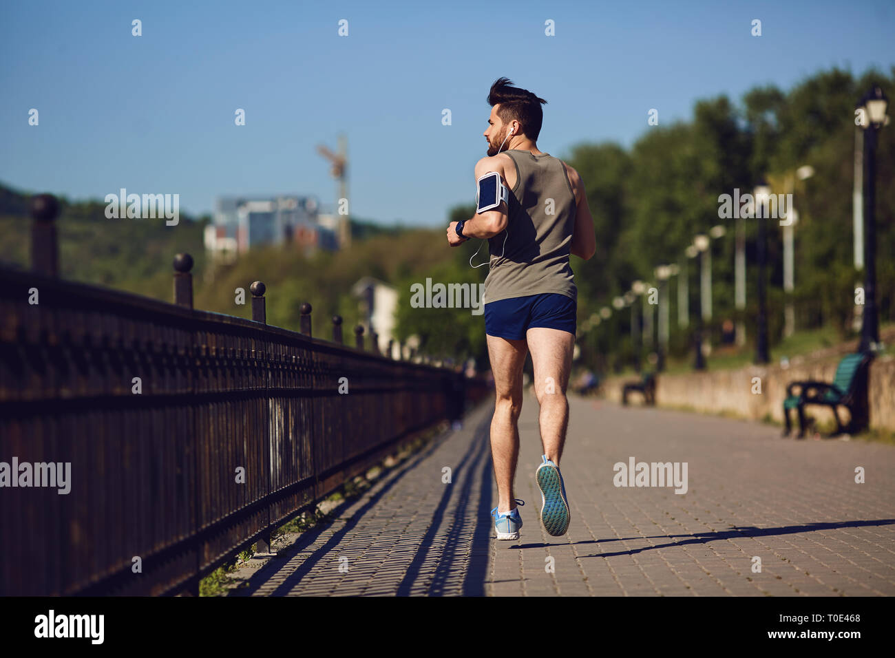 The sports guy runs through the park Stock Photo - Alamy