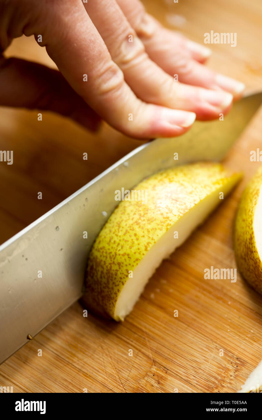Cutting slicing pears Stock Photo - Alamy