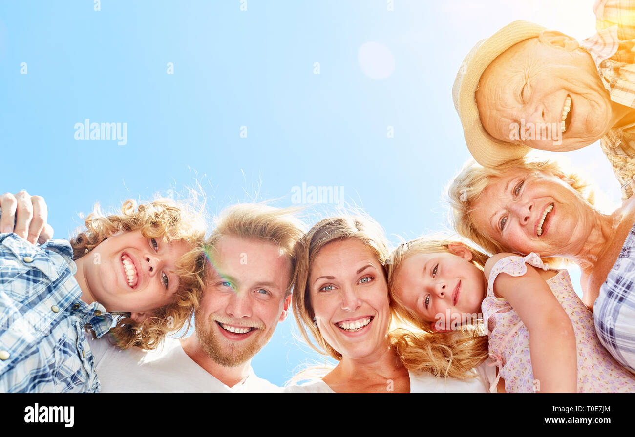 Happy extended family in three generations in front of a blue sky Stock ...