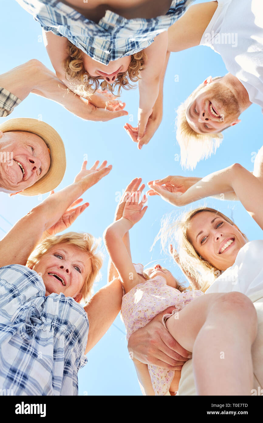 Cheering three generations family with grandparents and children in the ...