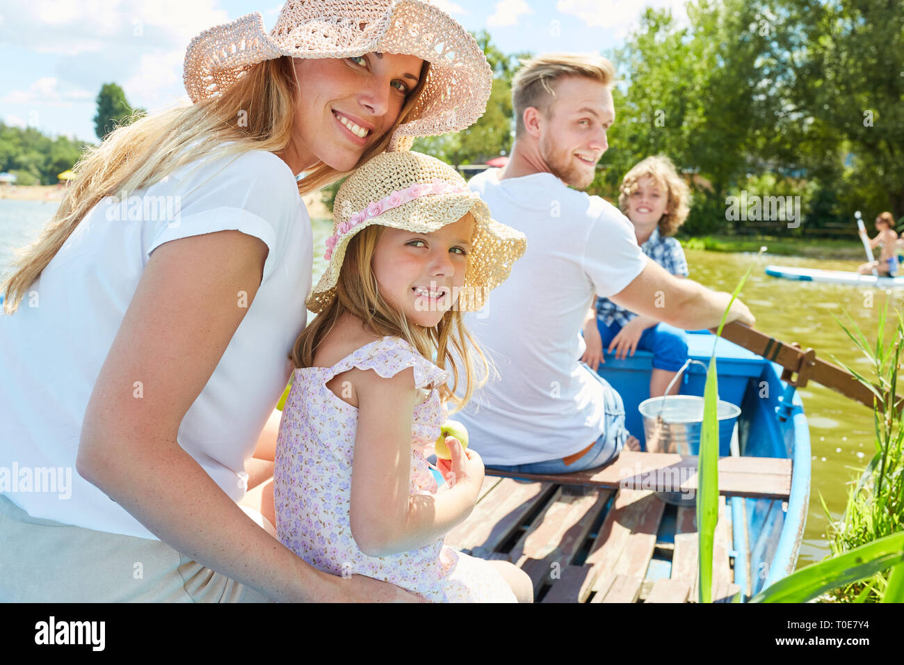 Happy family with two kids in rowboat on a boat tour on a lake Stock ...