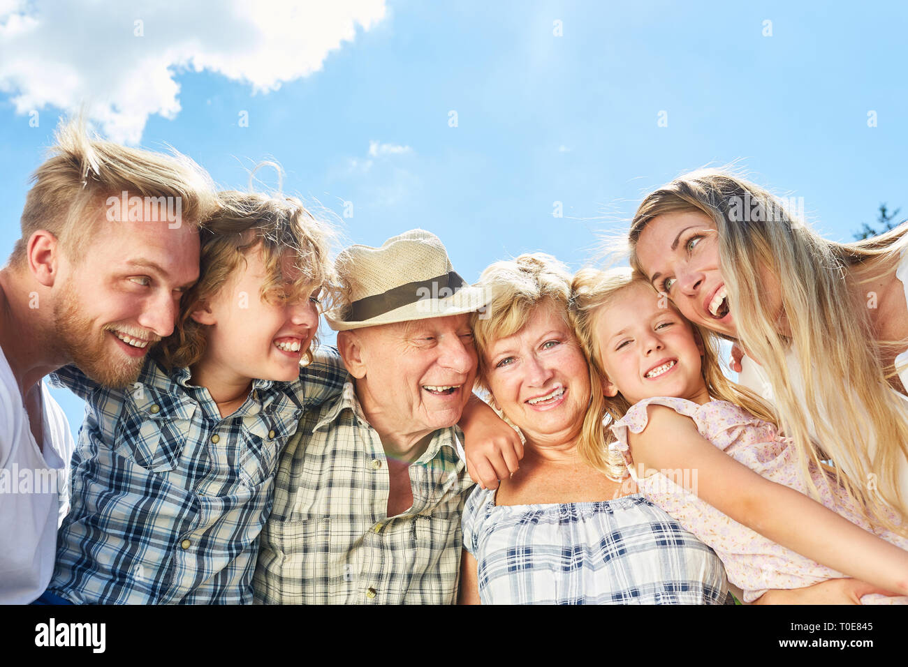 Three generations of family with grandparents and children as a happy ...