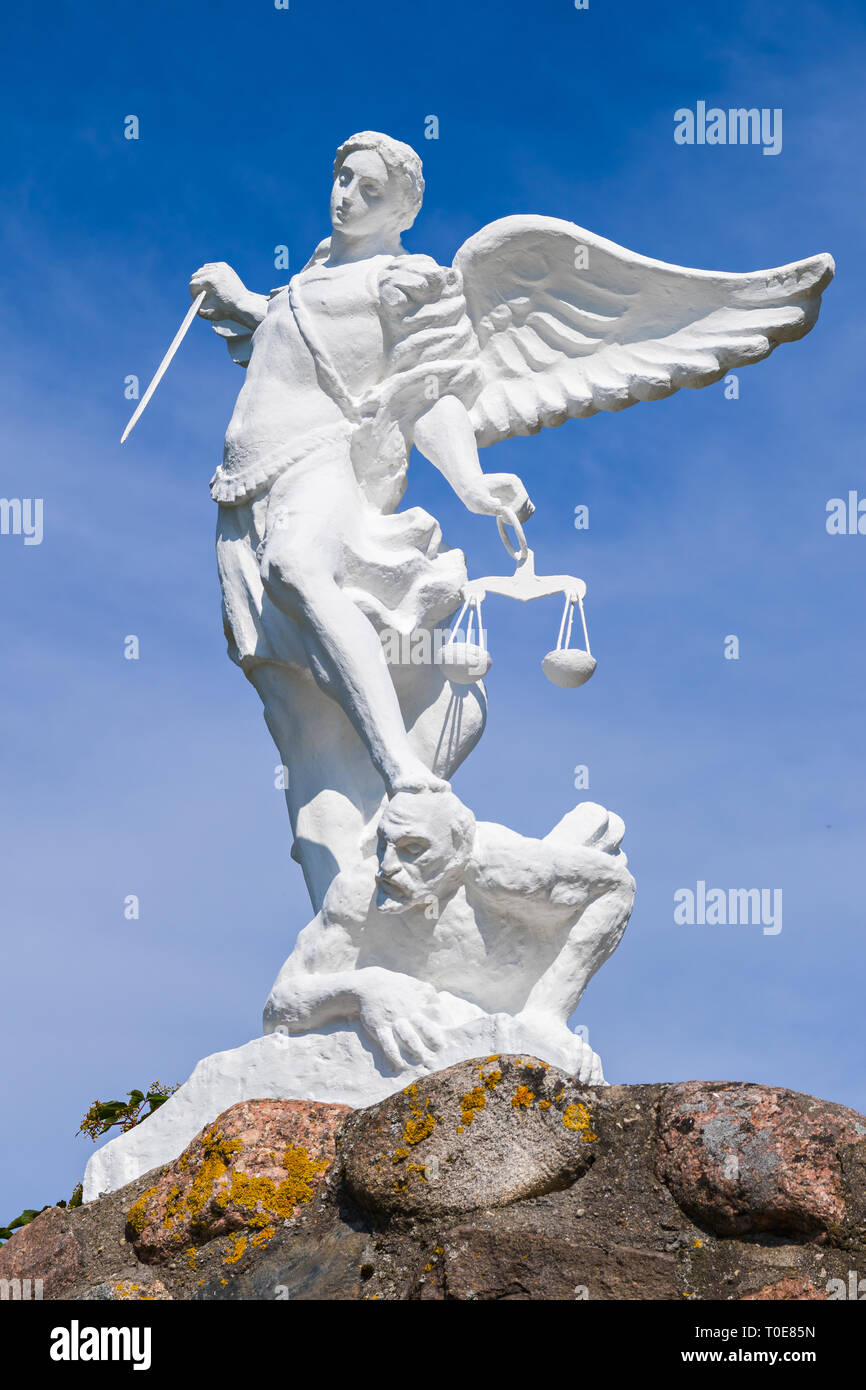 Sculpture of St. Michael the Archangel with a sword and libra striking ...