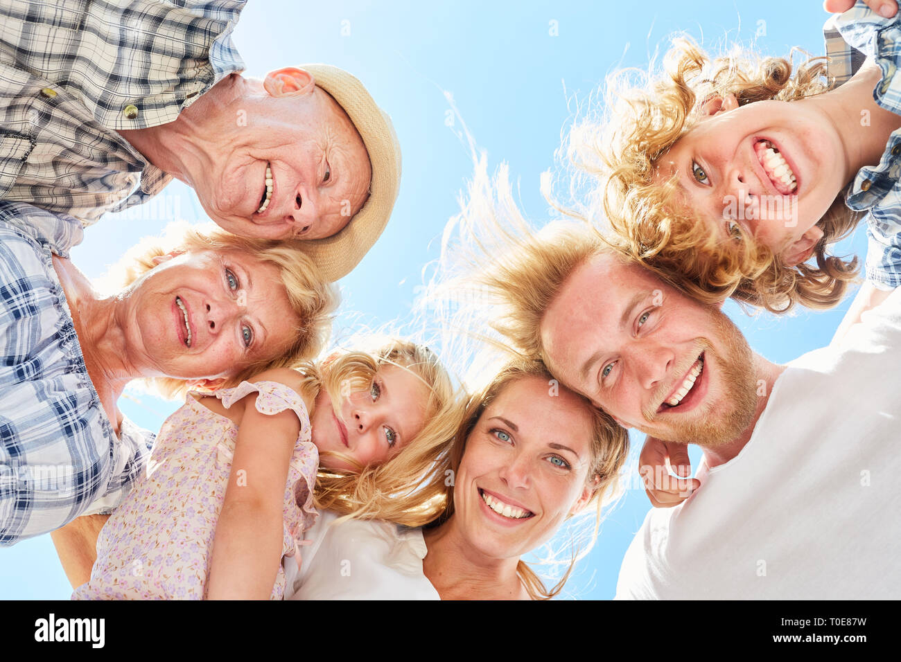 Happy extended family as a community with children and grandparents ...