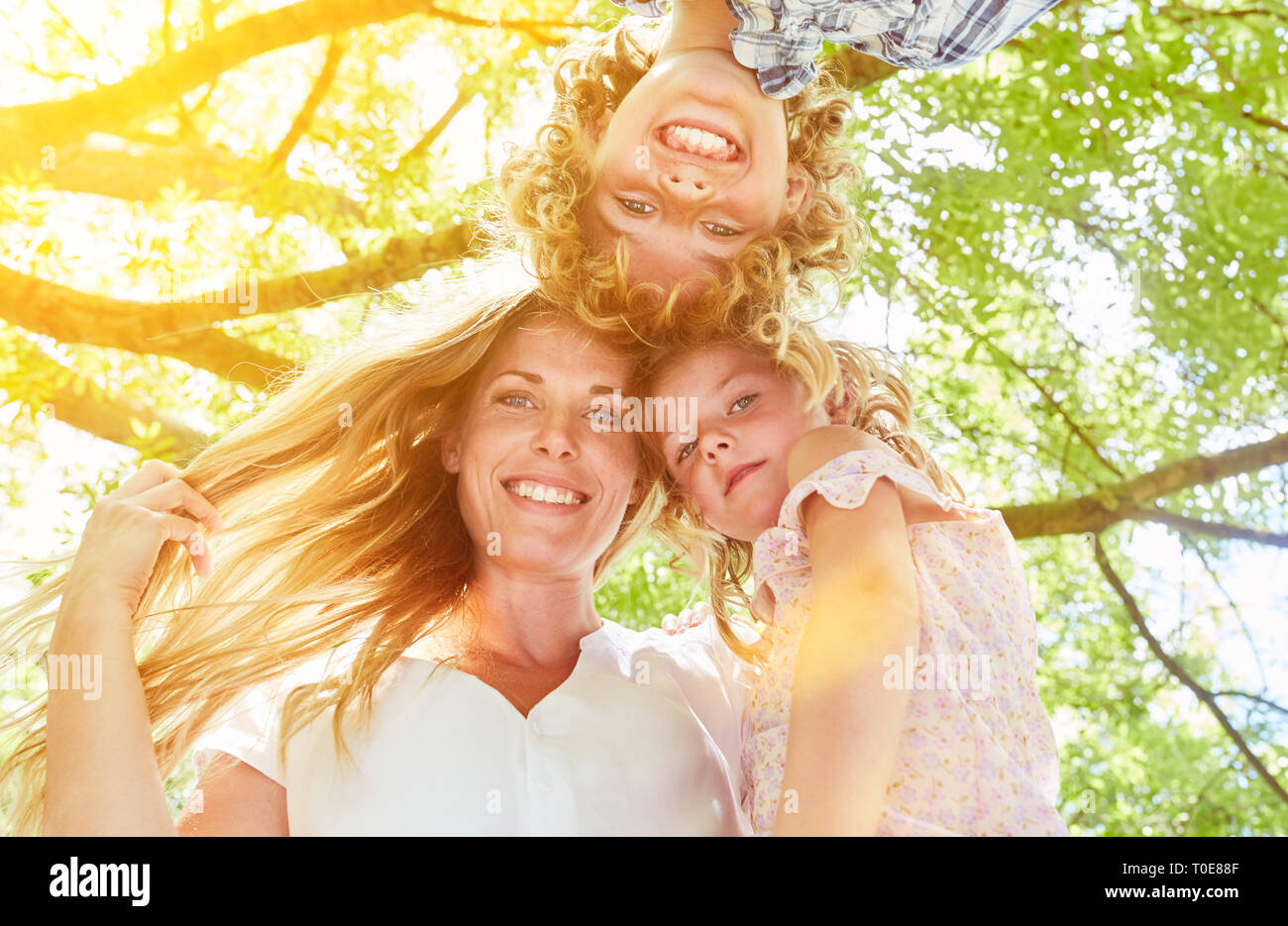 Single mother with two children in summer in nature Stock Photo - Alamy
