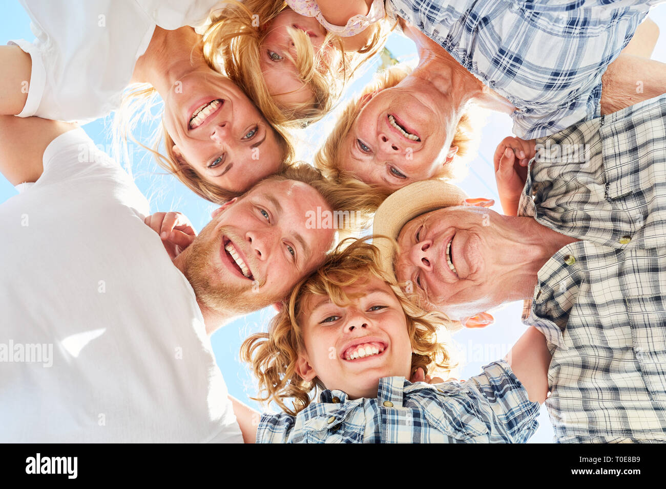 Three generations of family with children and grandparents laugh at the ...