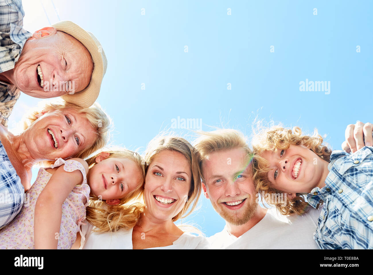 Laughing extended family in the summer with grandparents and two kids ...