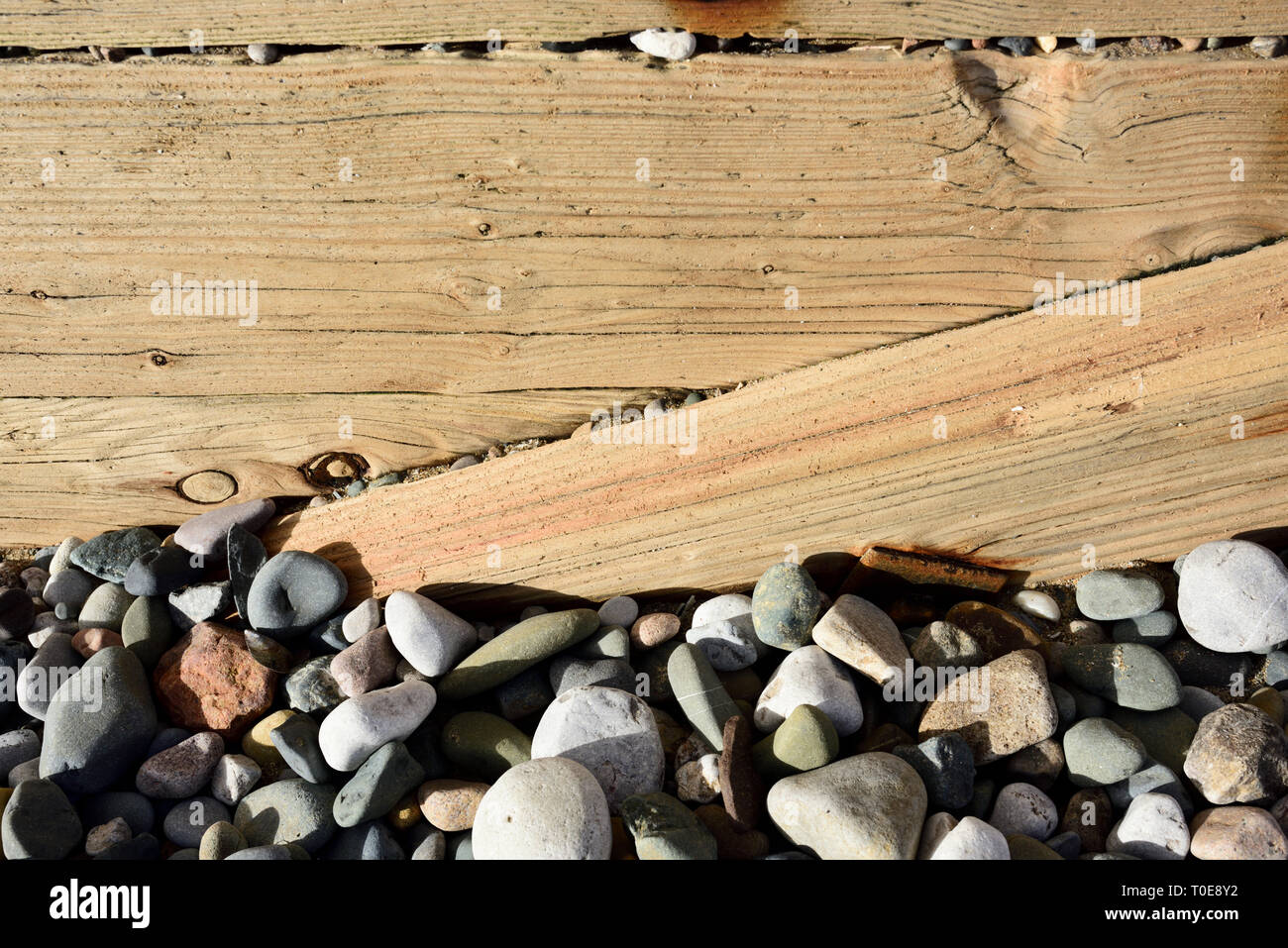 Wooden planking on timber groyne with shingle at base on cleveleys ...