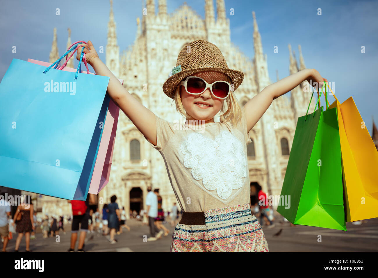 modern tourist girl in hat with colorful shopping bags rejoicing in the ...