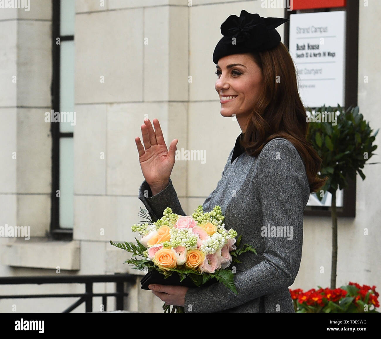 The Duchess of Cambridge, holds a bouquet of flowers as she leaves King ...