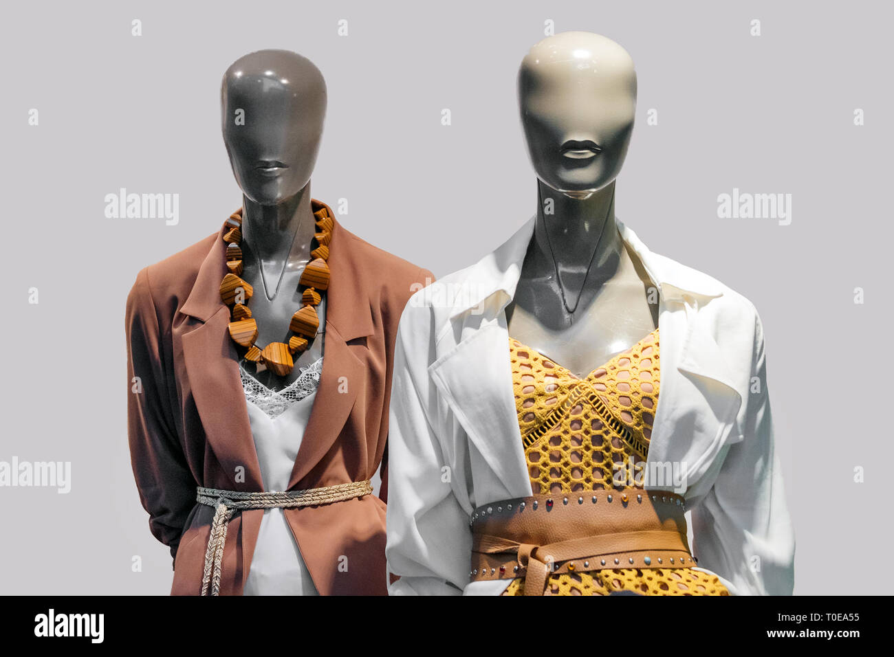 Female mannequins standing in store window display of women casual ...