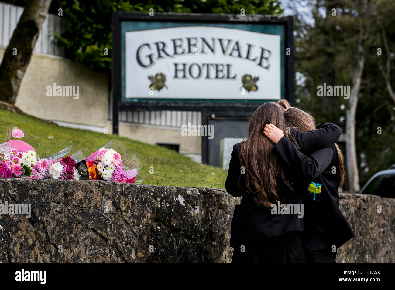 Students from Holy Trinity College leave floral tributes outside The ...