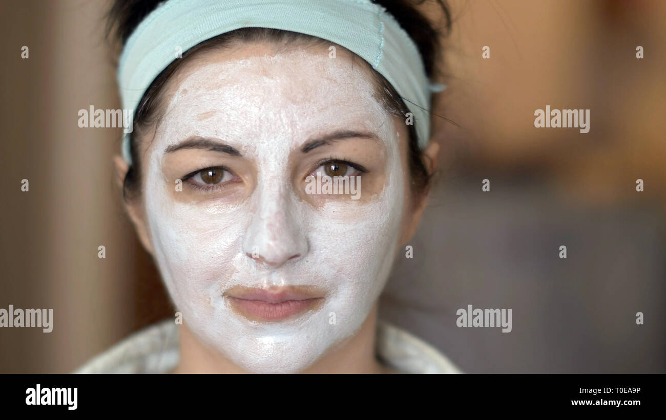 portrait of a woman with a cosmetic mask put on her face, a mask for ...