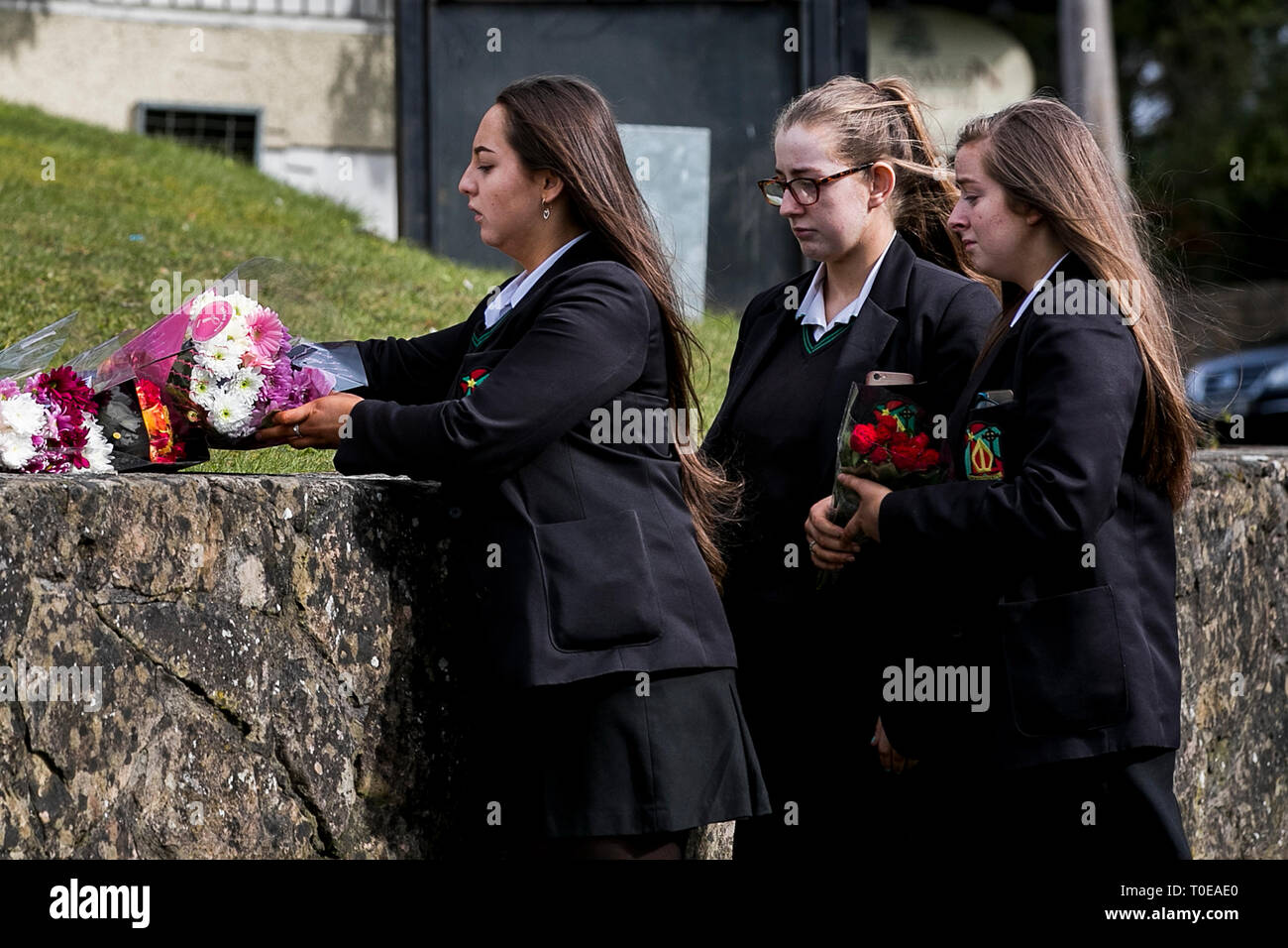 Students from Holy Trinity College leave floral tributes outside The ...