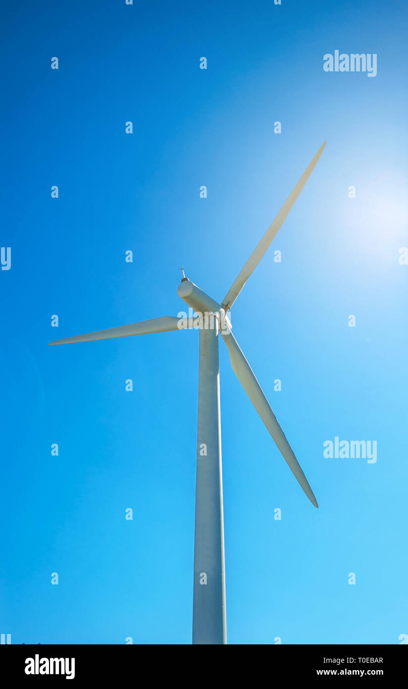 Big white propeller of wind power plant on the blue sky background ...