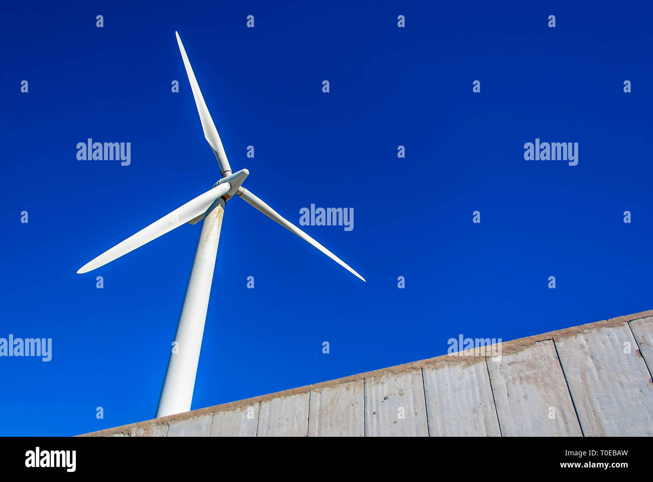 Big white propeller of wind power plant on the blue sky background ...