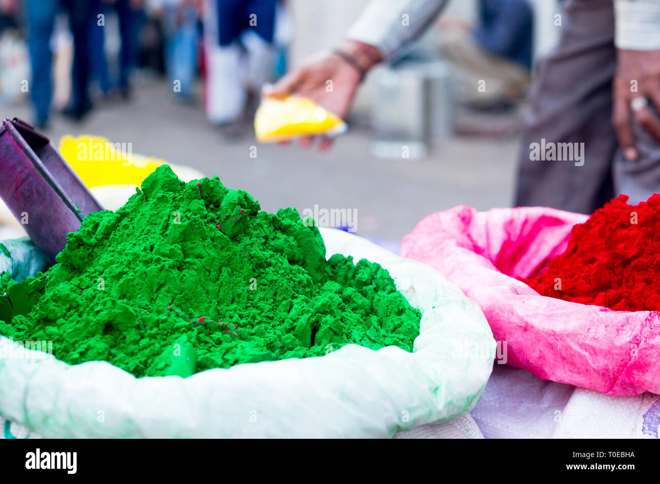 Green gulal powder placed in a pile with a steel iron scoop to measure ...