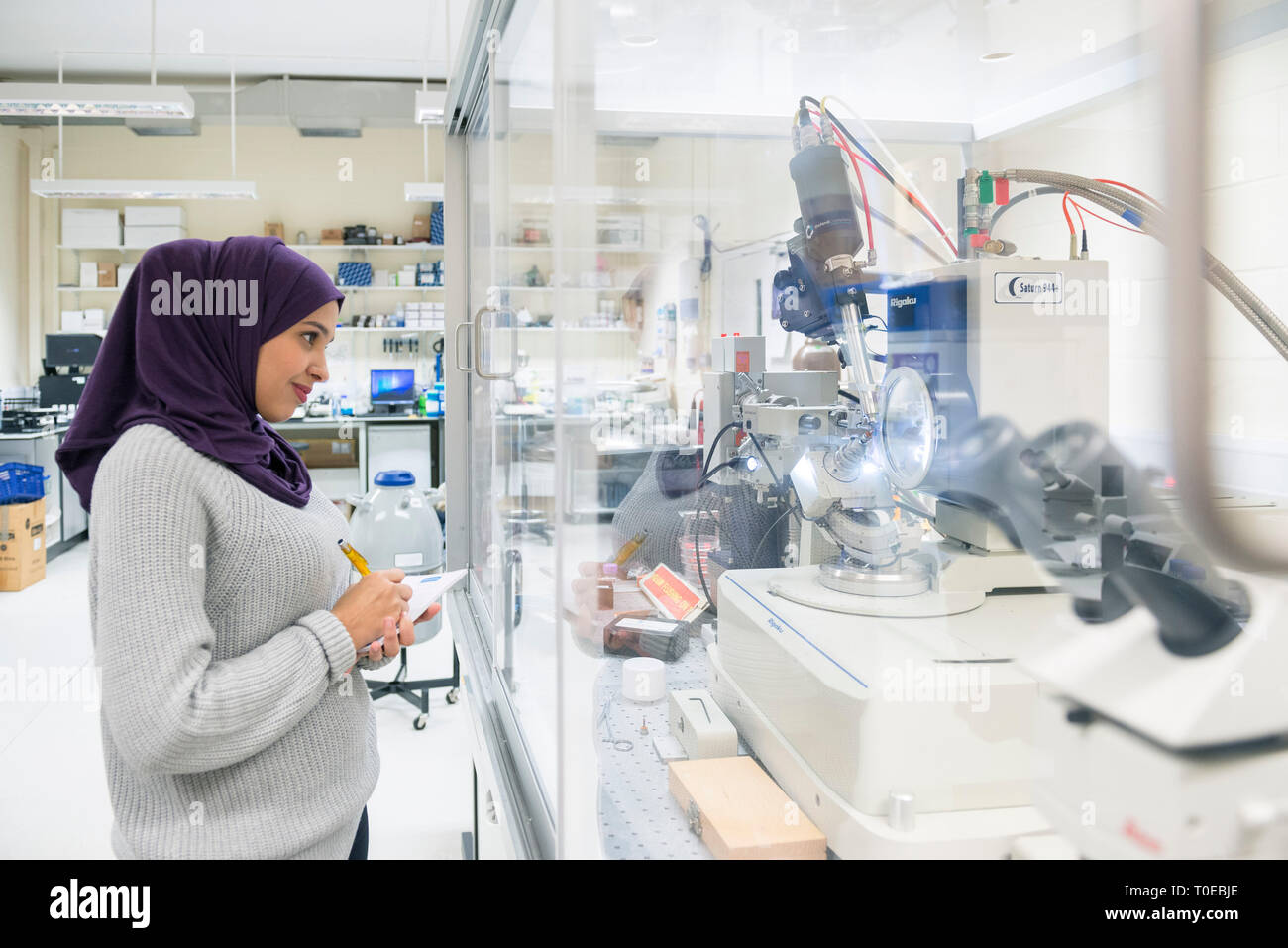 A muslim woman uses the scientific equipment in a research laboratory ...