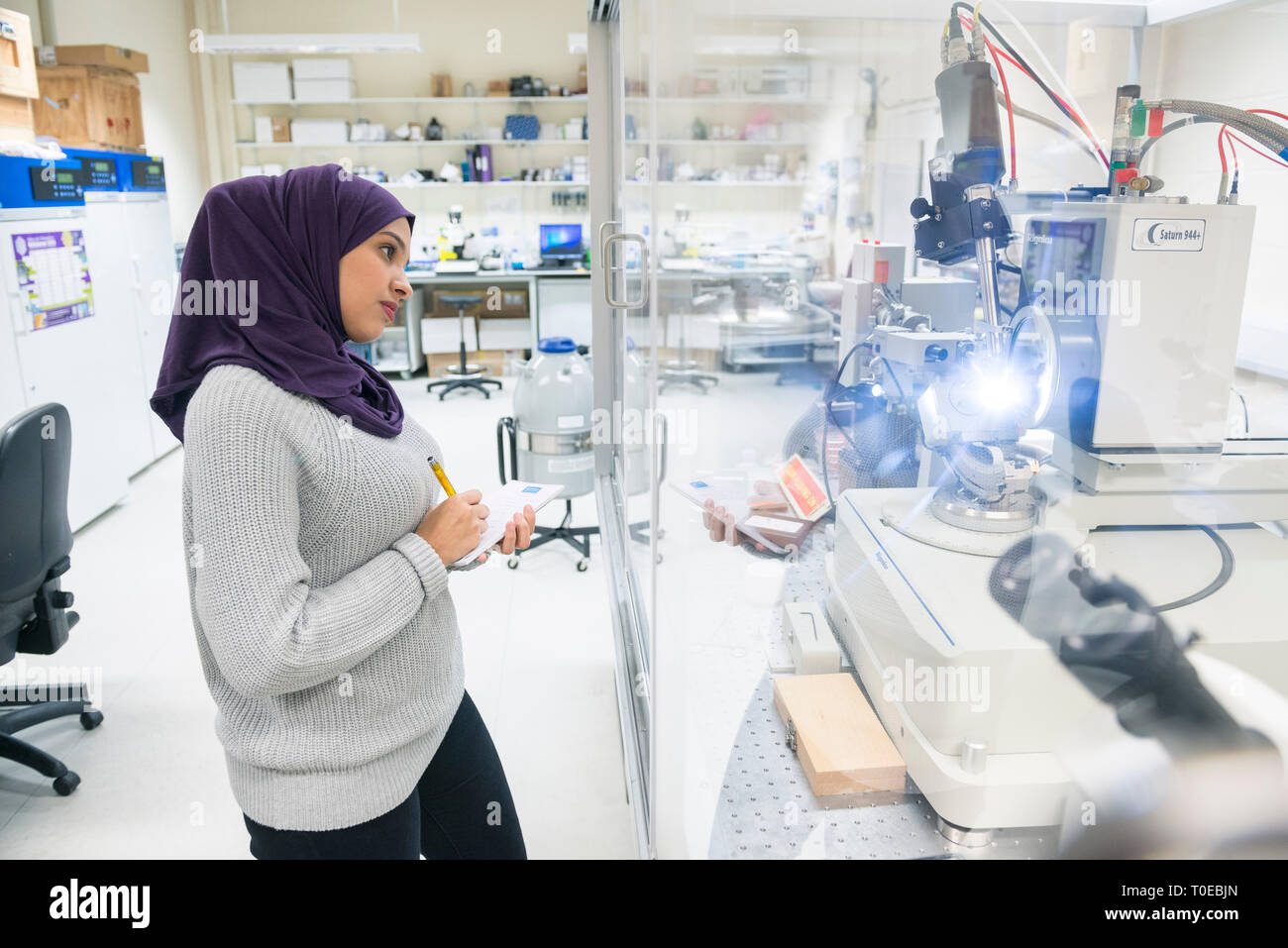 A muslim woman uses the scientific equipment in a research laboratory ...