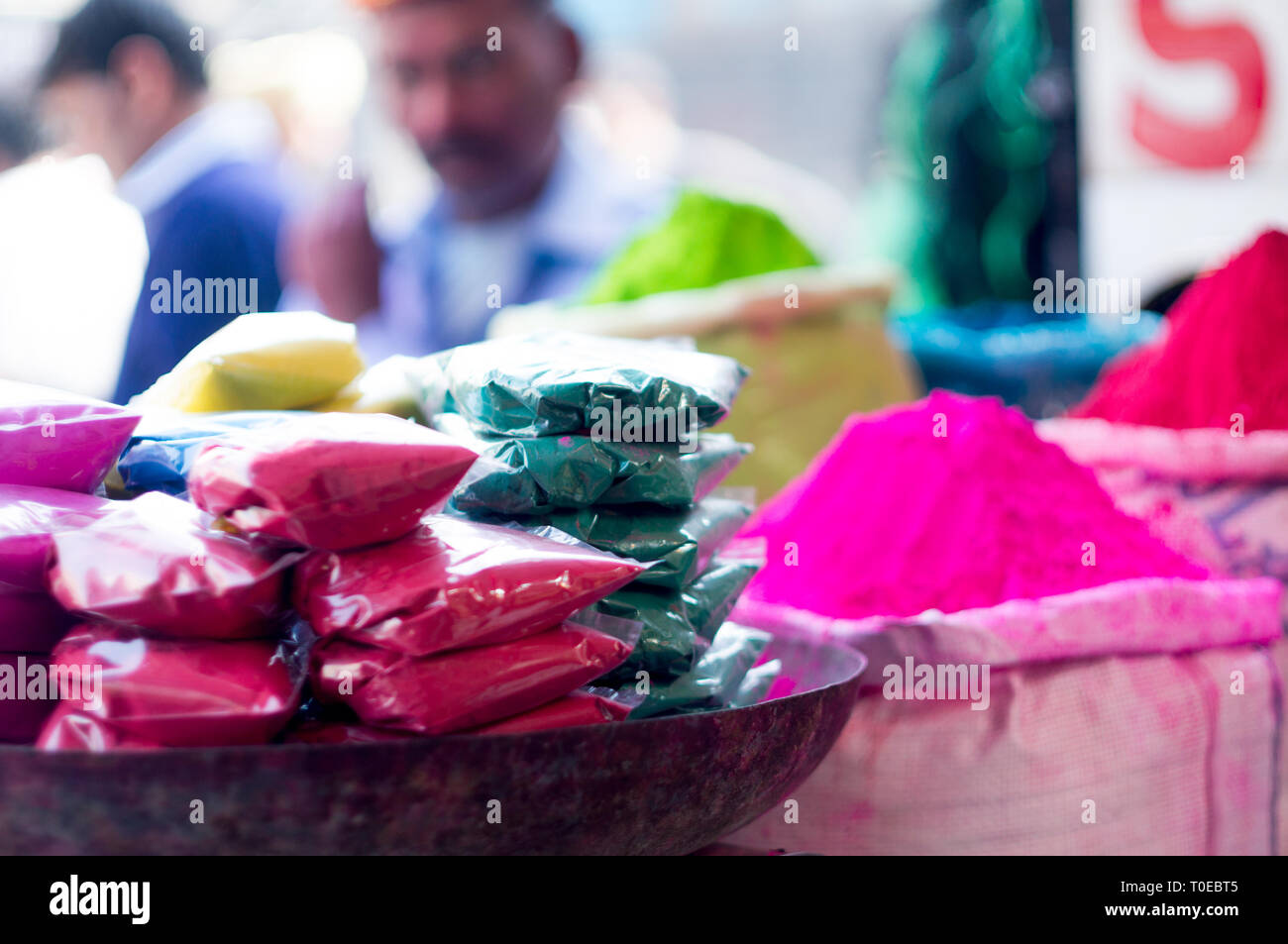 Colorful gulal powder placed as piles and in premade polythene packets ...