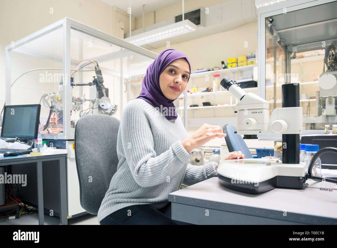 A muslim woman uses the scientific equipment in a research laboratory ...