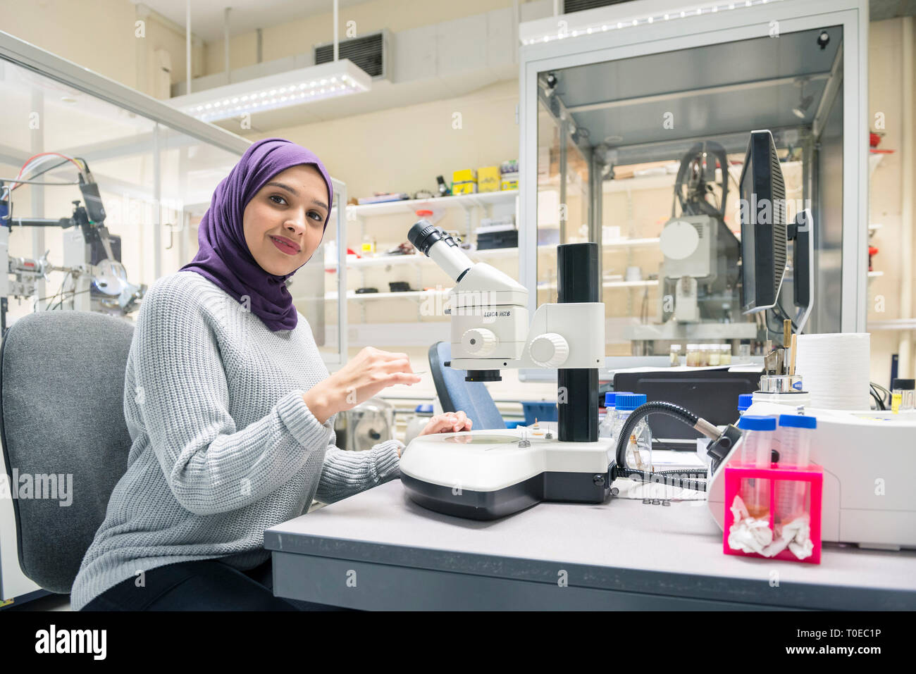 A muslim woman uses the scientific equipment in a research laboratory ...