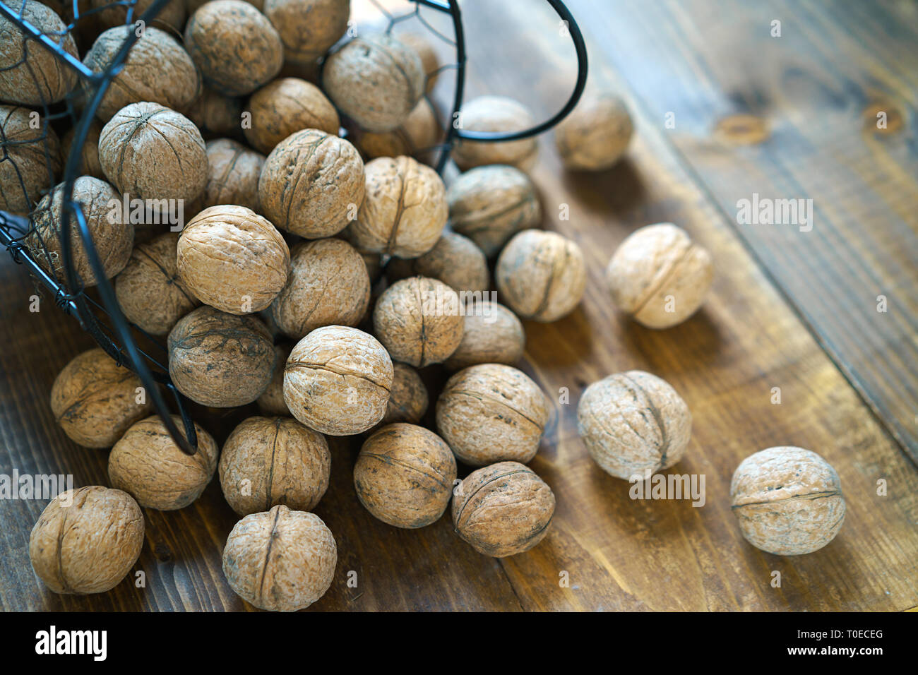 Raw organic walnuts in the shell on old brown wooden background in ...